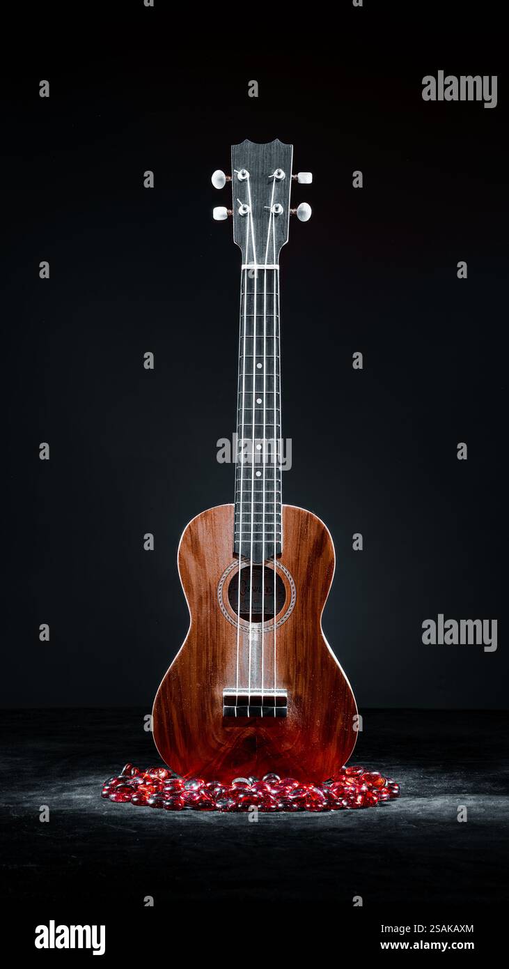 Ukulele, light painting in the dark, brown background, black foreground ...