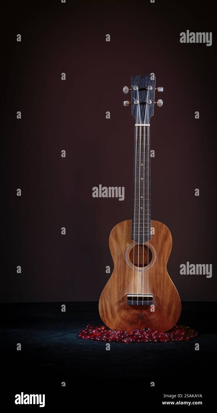 Ukulele, light painting in the dark, brown background, black foreground ...