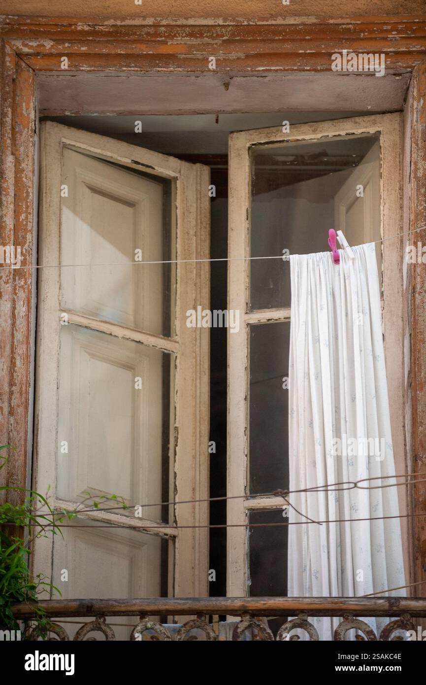 Rustic Italian Window with Weathered Wooden Shutters and a Hanging ...