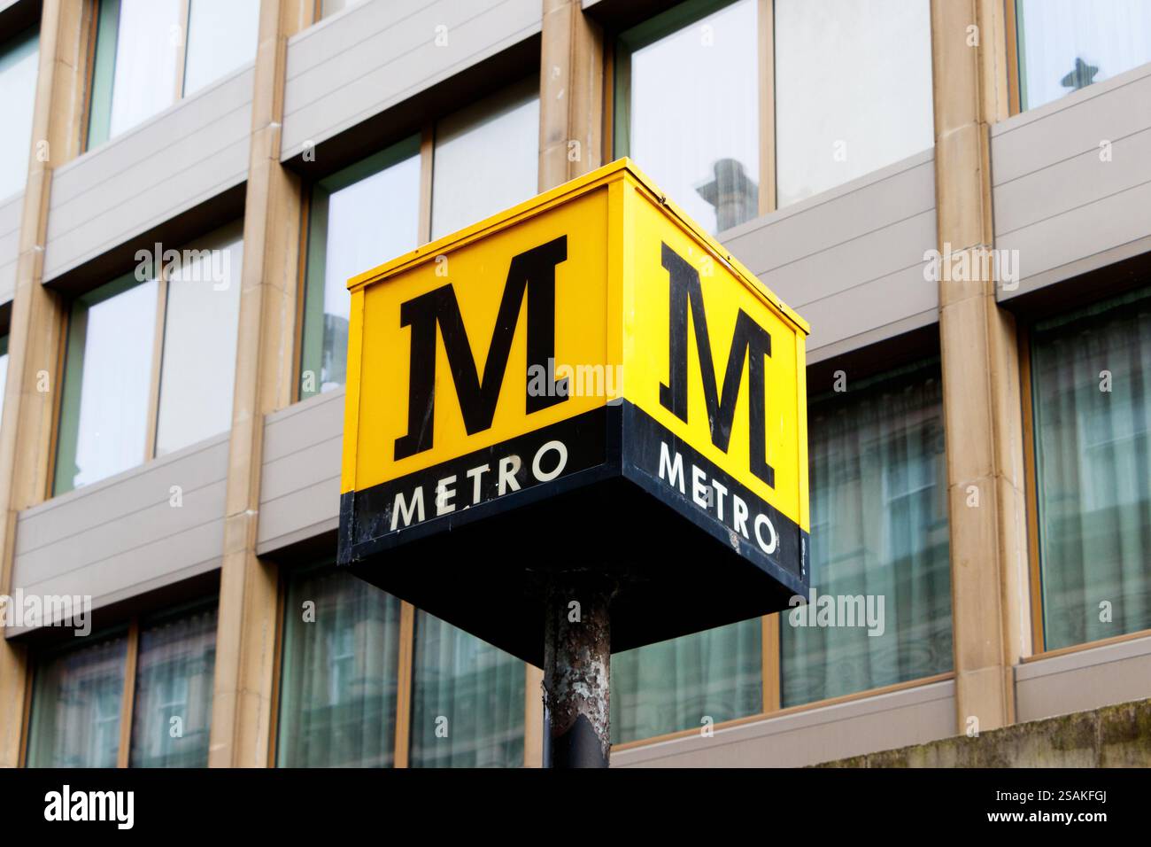 Close-up of the iconic yellow and black cubic metro sign with letter M ...