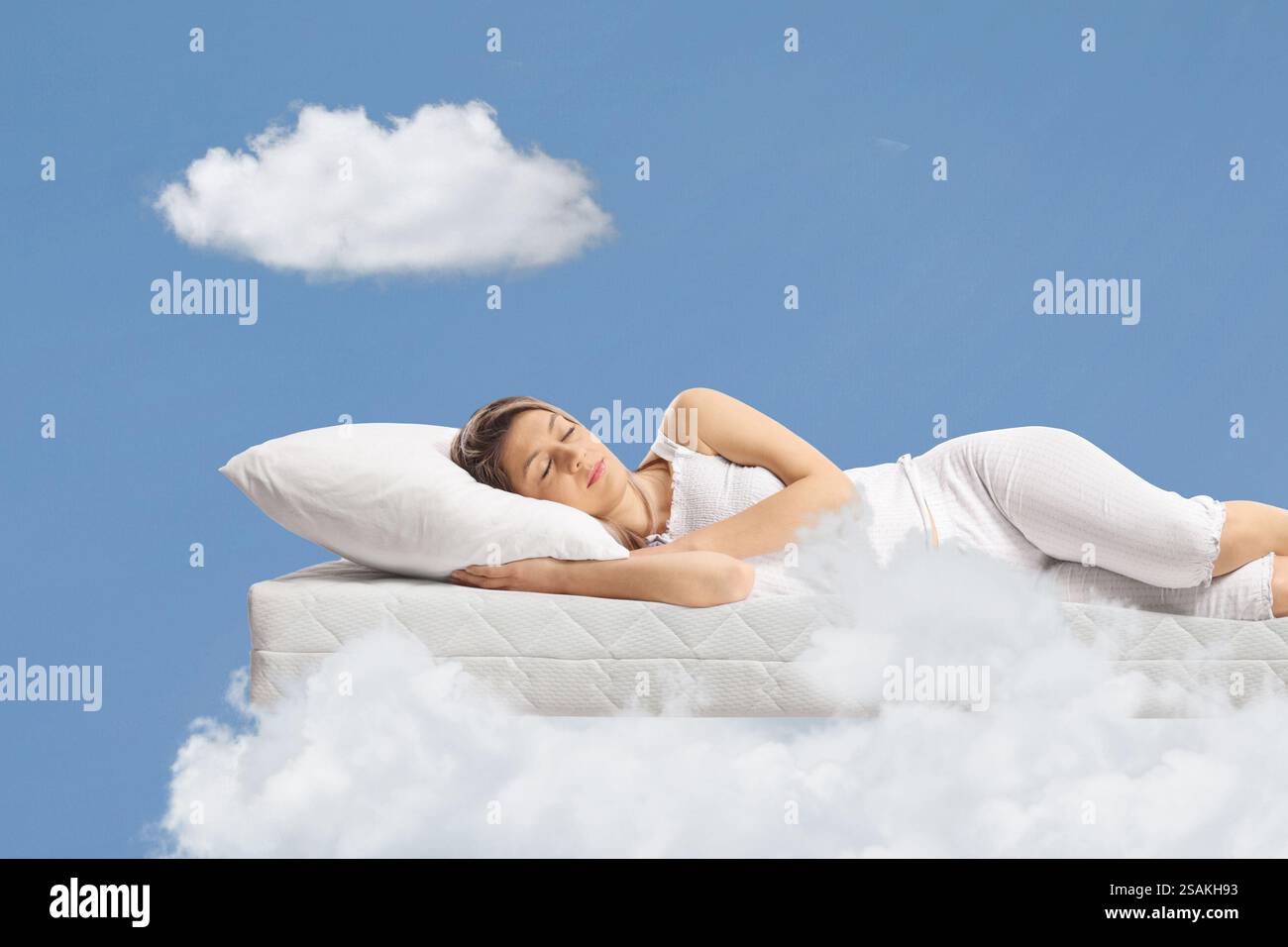 Young woman sleeping on a floating mattress between clouds Stock Photo ...