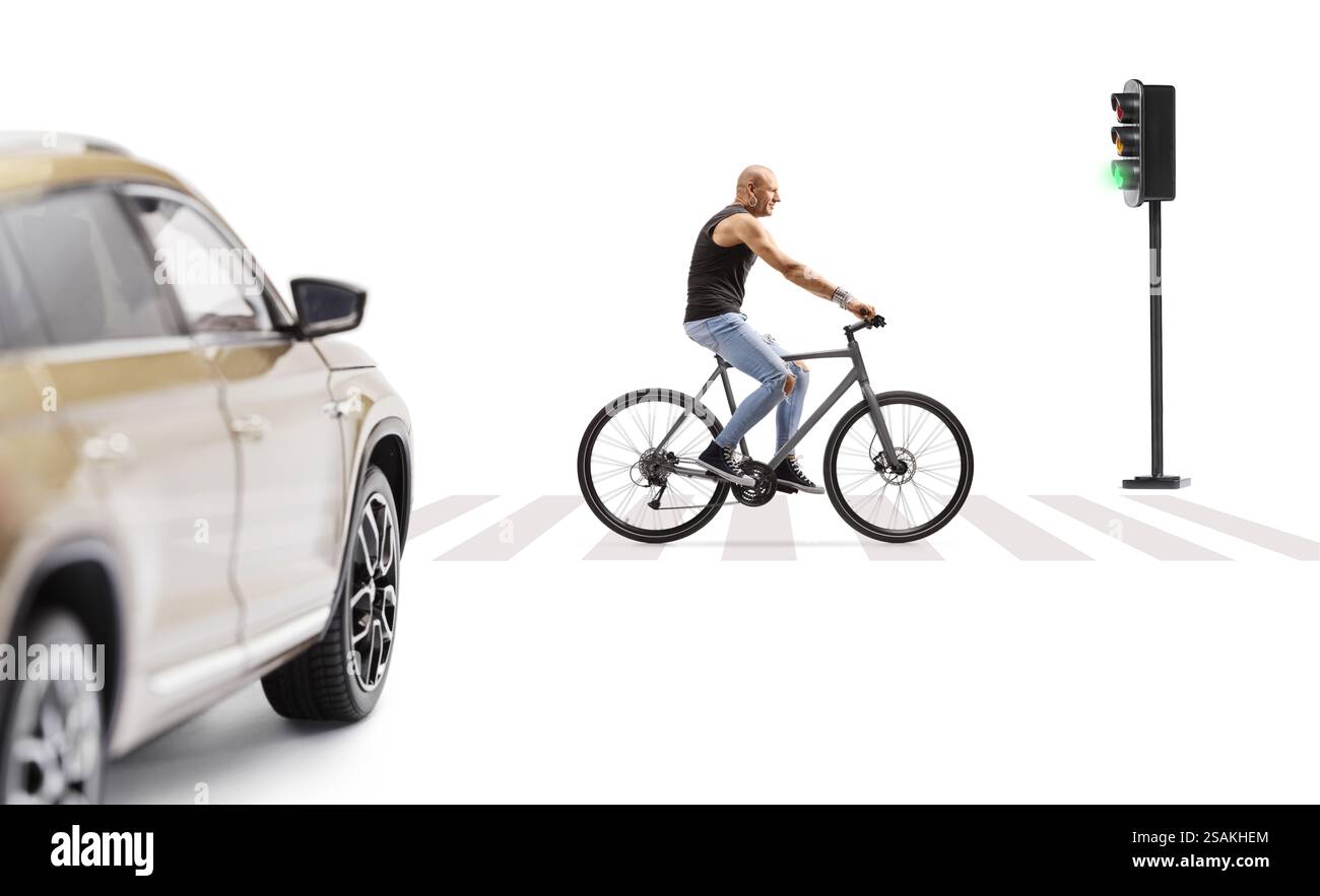 Car stopping at green traffic light and guy riding a bicycle at a ...