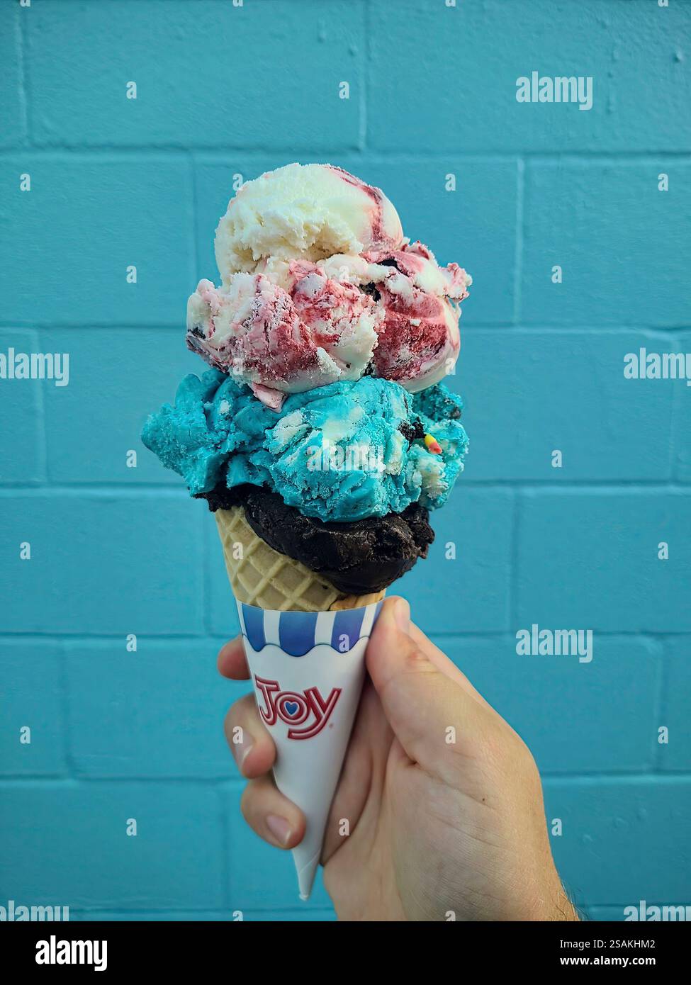 Colorful Ice Cream Cone Against Blue Brick Wall Eye-Level Perspective ...