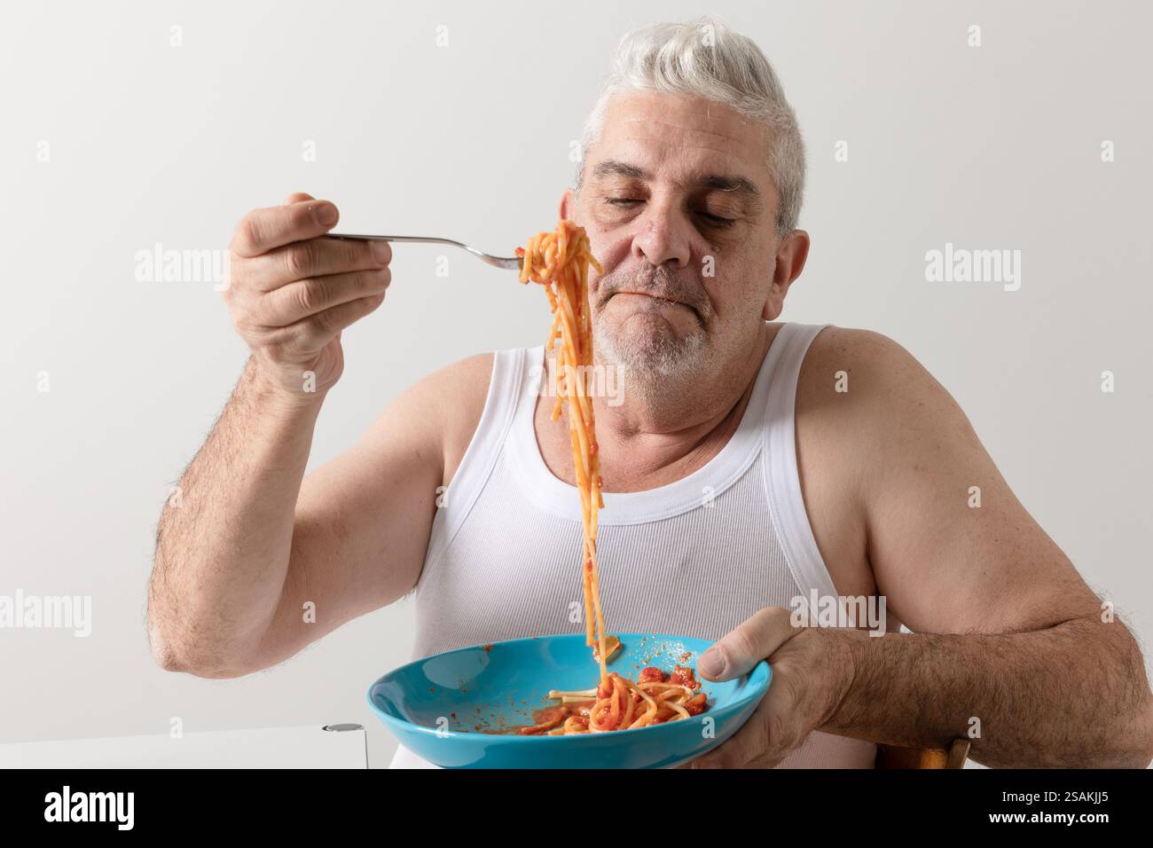 A typical southern Italian man from Puglia, seen from the front holding ...