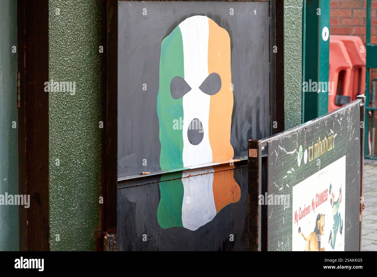 green white and orange balaclava mural kneecap outside maddens bar ...