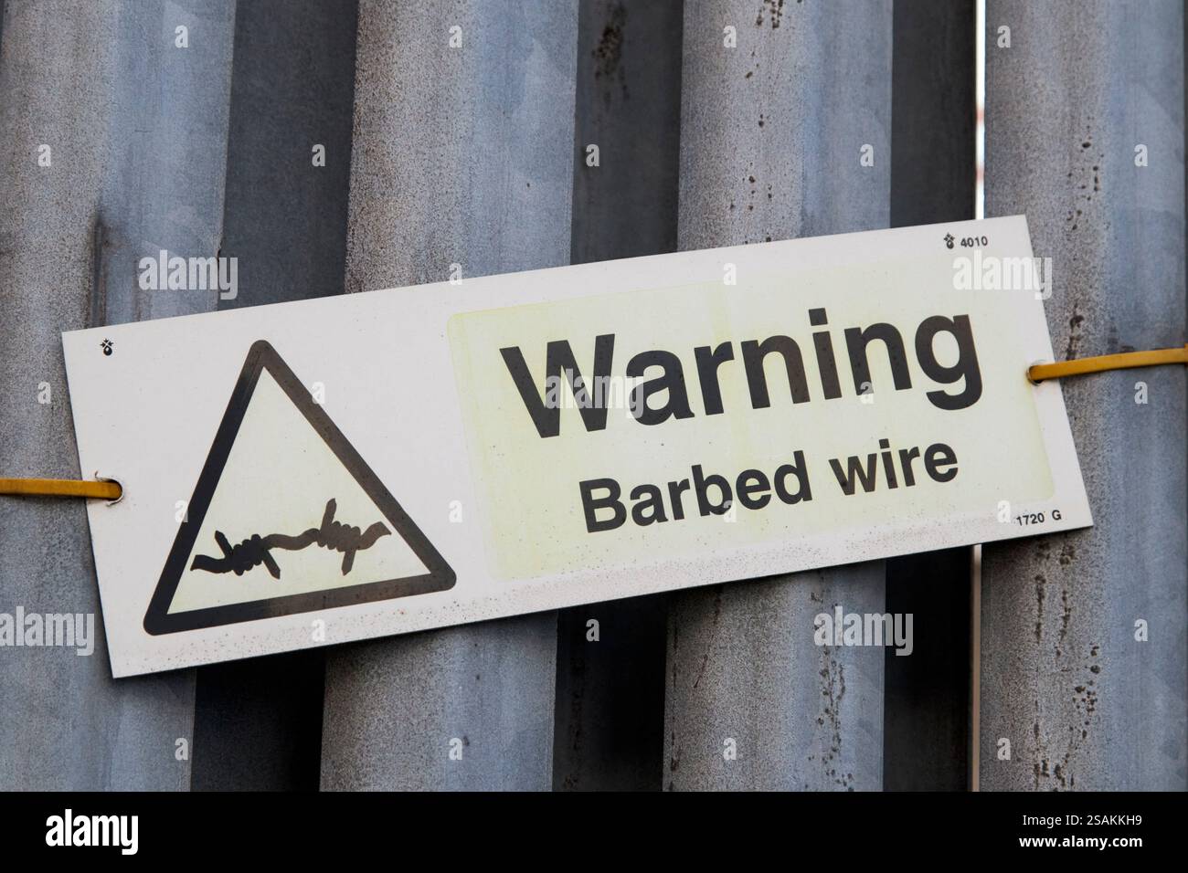 warning barbed wire sign on metal fence belfast, northern ireland, uk ...