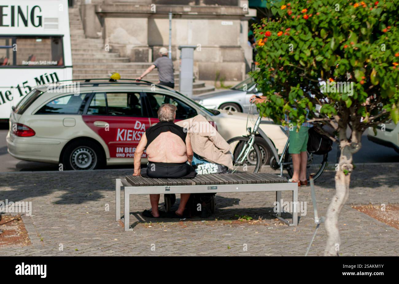 Fat man on bench in Berlin, Germany Stock Photo - Alamy