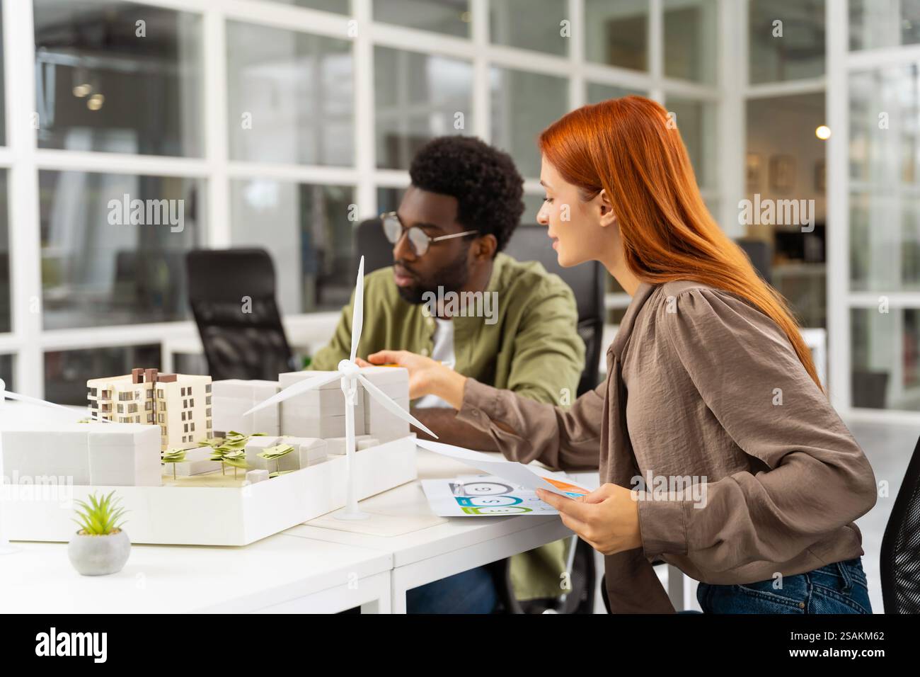 Two young architects working together on a new sustainable project ...