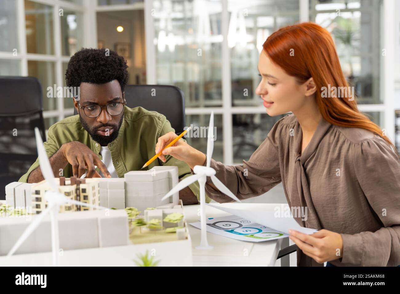 Two young architects working together on a new sustainable project ...