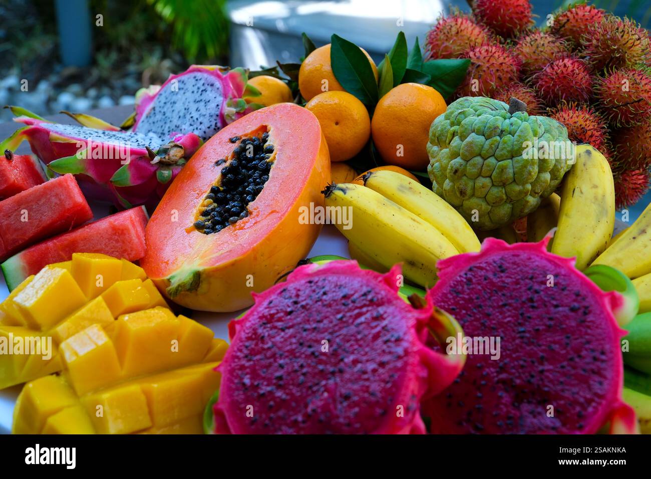 Exotic fruit shop display, papaya, yellow mango, dragon fruit, rambutan ...