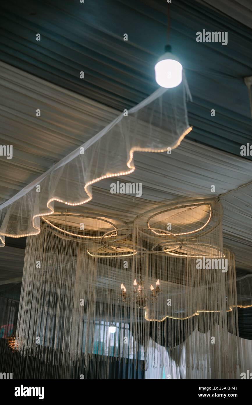 Decorative ceiling installation with white drapes and lights Stock ...