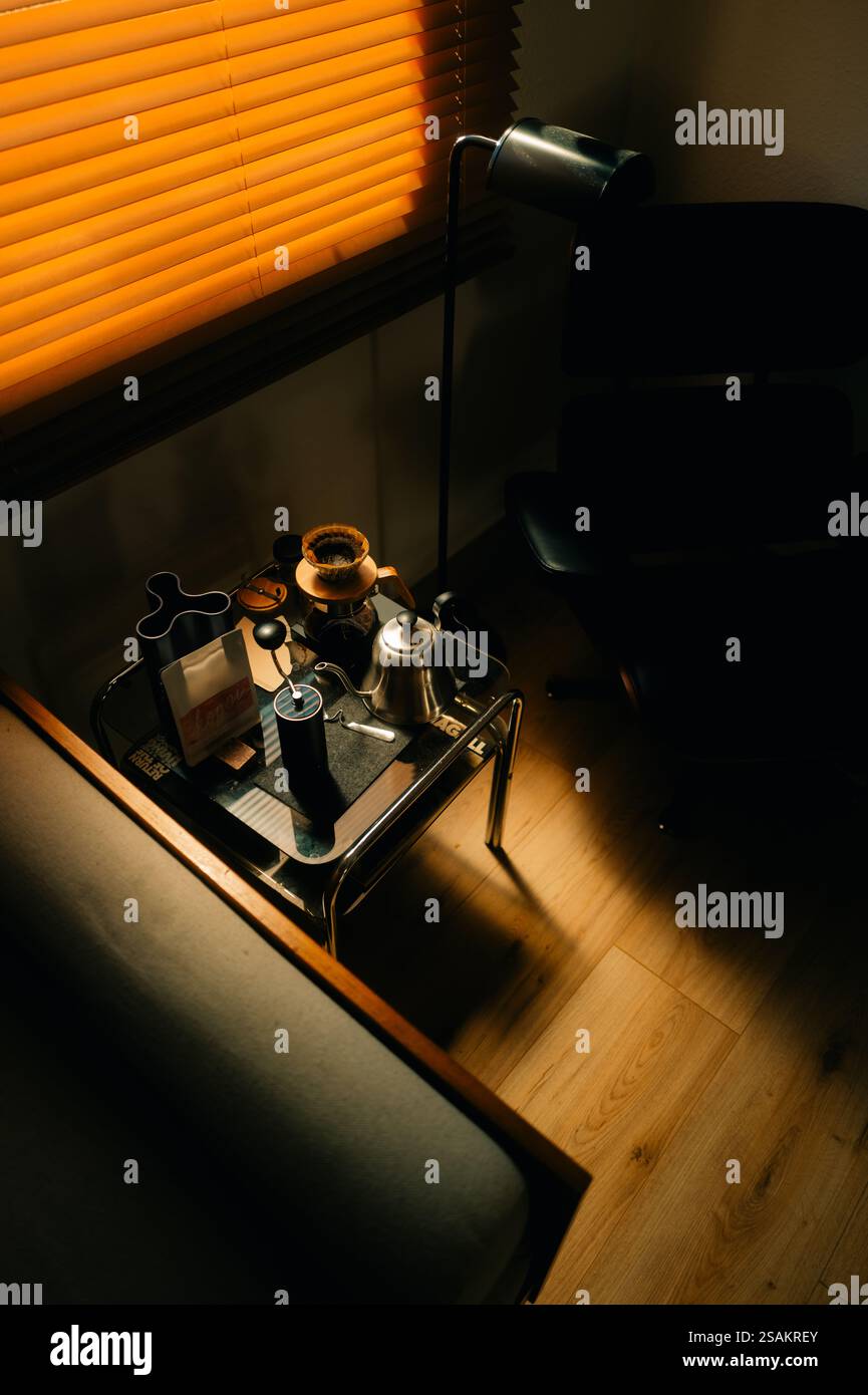 A cozy coffee corner with brewing tools on a small table, illuminated ...