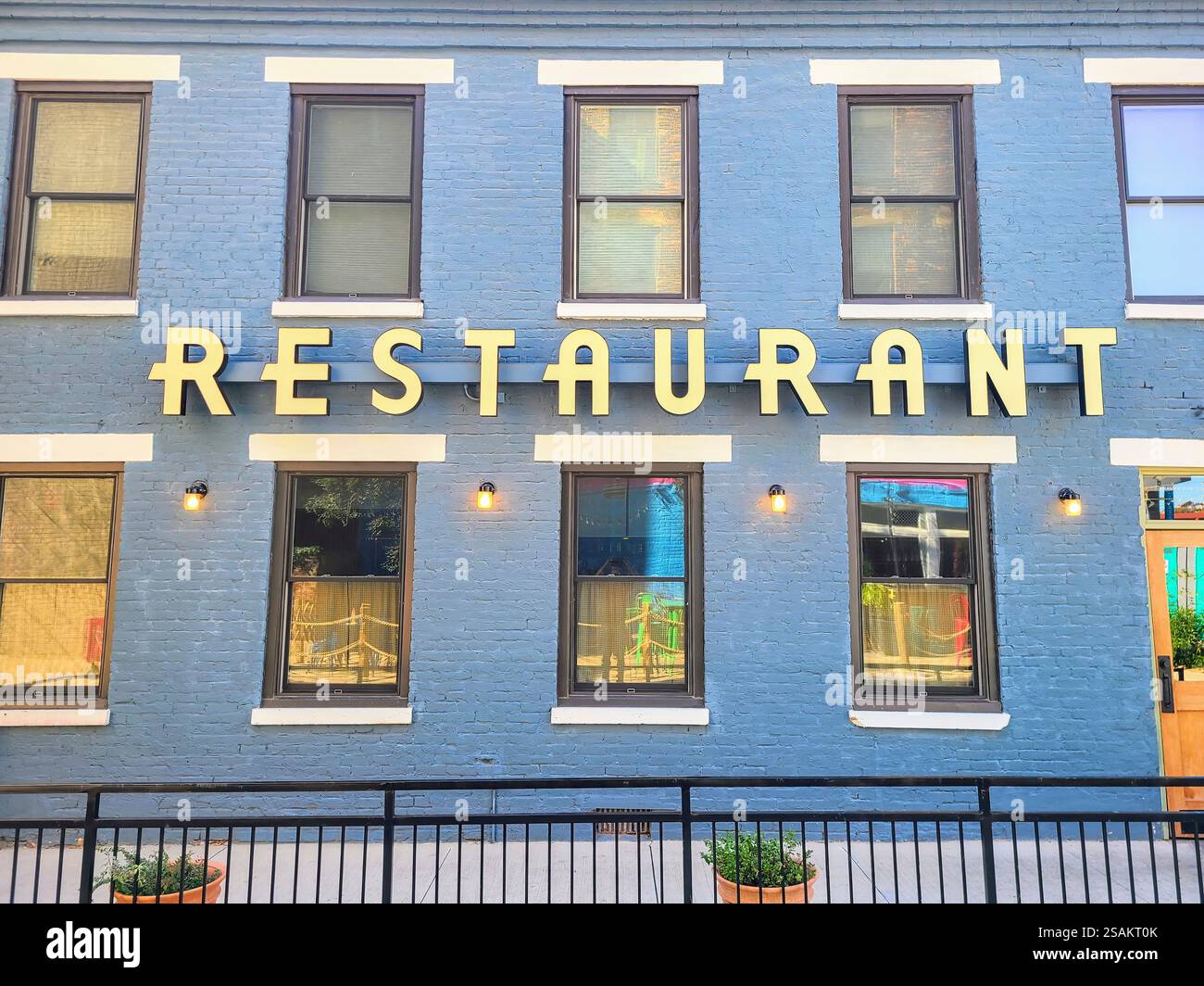 Blue Brick Restaurant Facade with Bold Yellow Sign Eye-Level View Stock ...