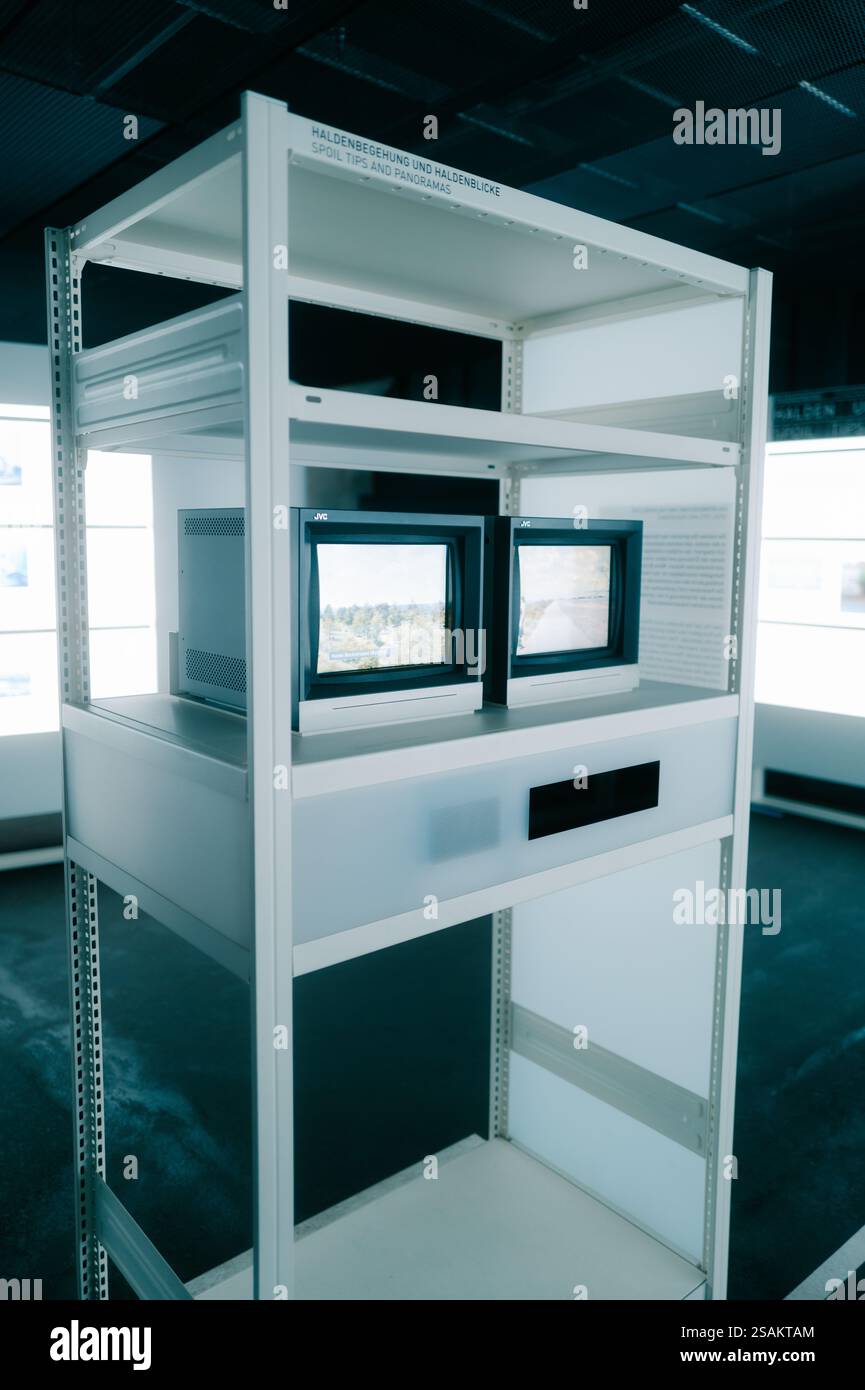 A minimalist exhibition setup featuring two vintage JVC monitors placed ...