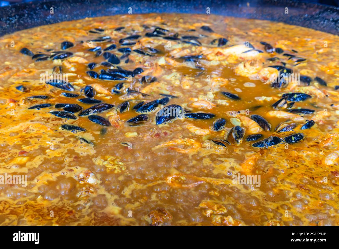 Authentic Spanish Paella Cooking. Rich Colors, Black Mussels, and ...