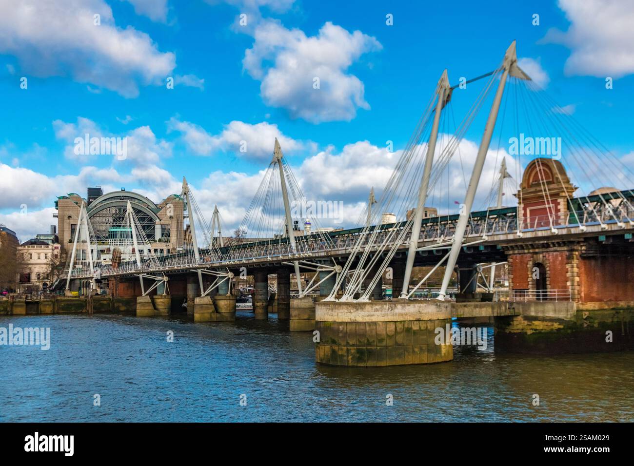 Great view of the Hungerford Bridge over London's river Thames, flanked by cable-stayed ...
