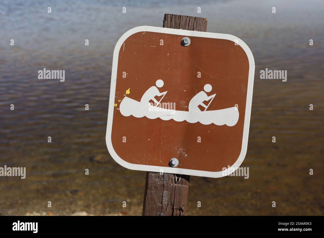 Canoeing sign posted at waterfront Stock Photo - Alamy