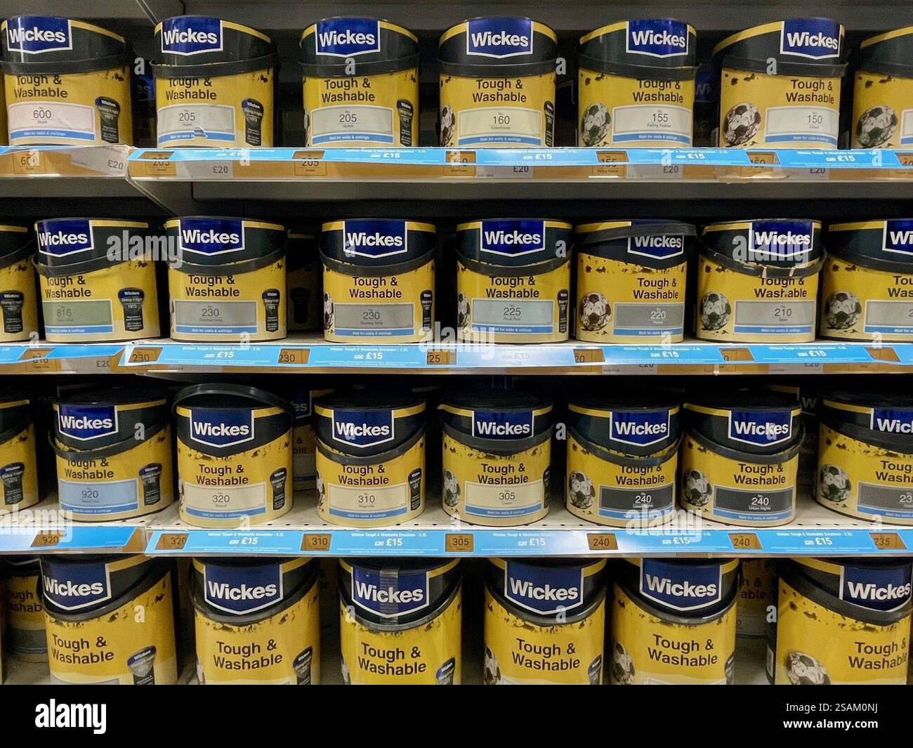 A general view of shelves with emulsion paint on display, inside Wickes ...