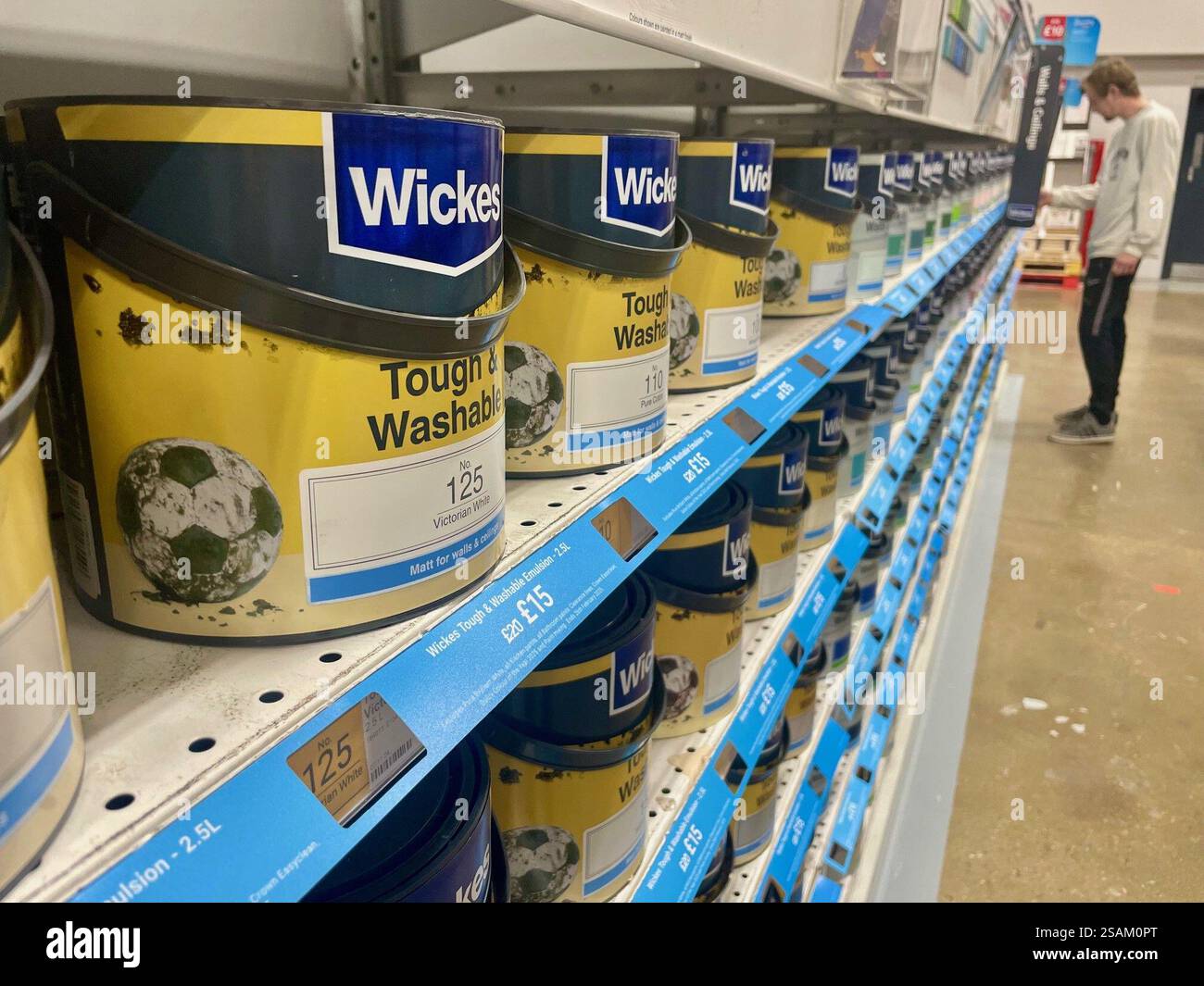 A general view of shelves with emulsion paint on display, inside Wickes ...
