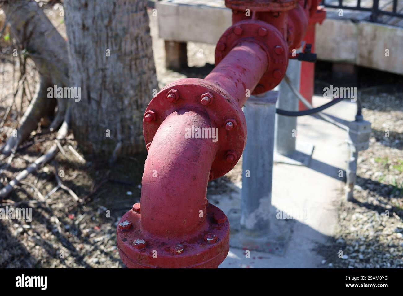 Red metal utility pipe with joint and fasteners Stock Photo - Alamy