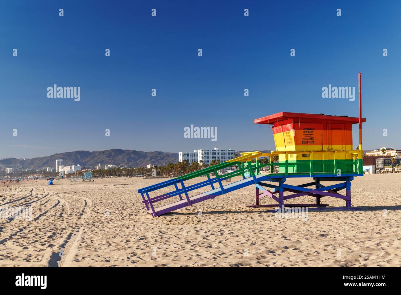 Vibrant lifeguard tower painted in LGBTQ rainbow colors, standing ...