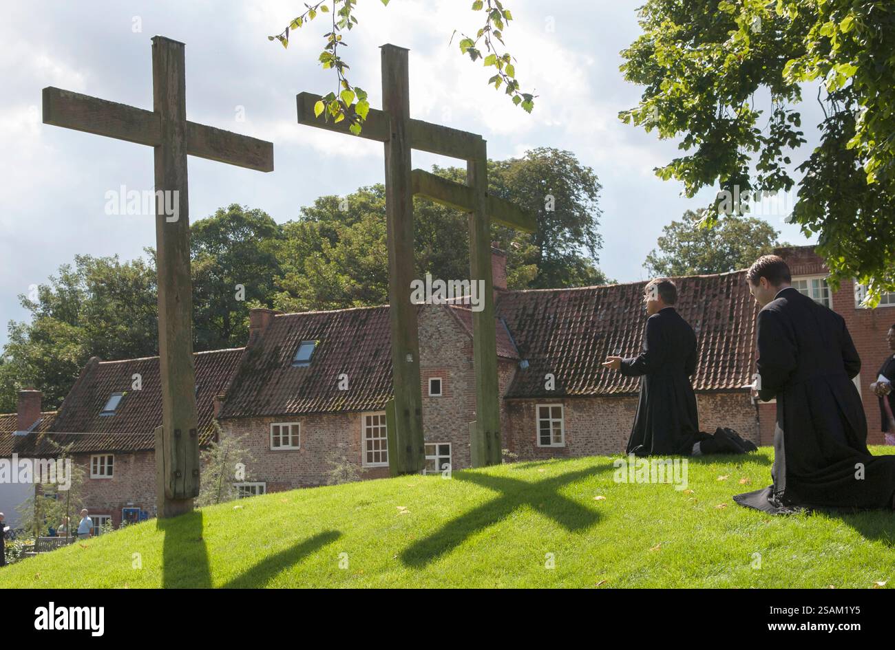 Pilgrimage England. Anglican priest praying kneeling at the Three ...