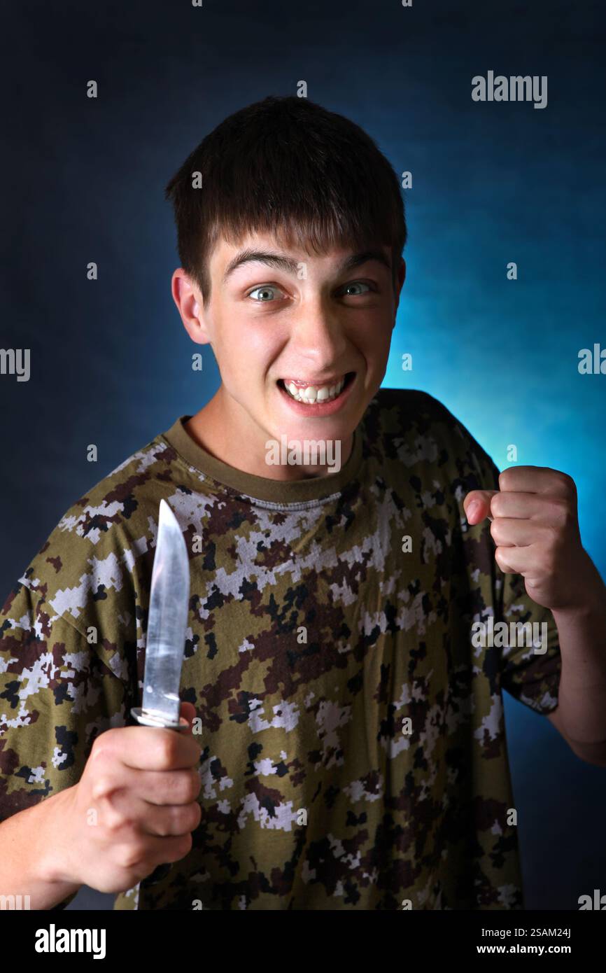 Angry Teenager with Knife On the Dark Background Stock Photo - Alamy