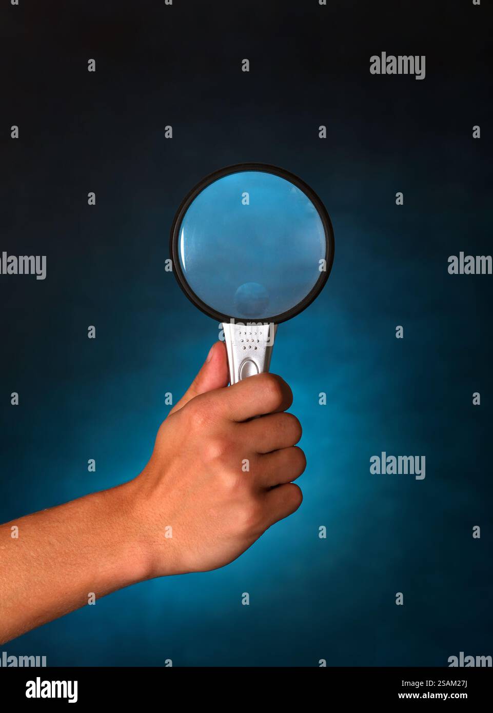 Hand with Loupe on the dark background Stock Photo - Alamy