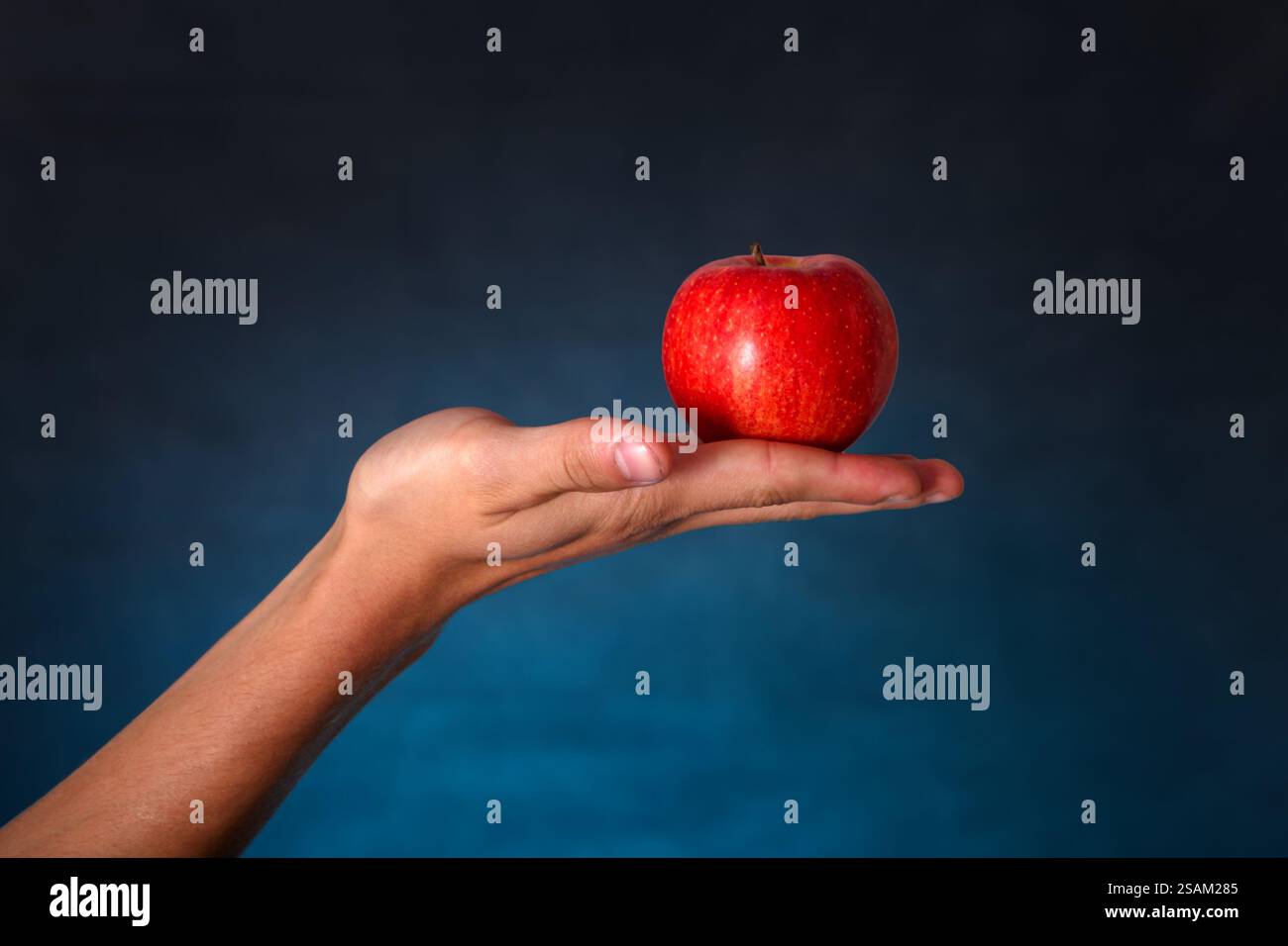 Hand holding red apple dark hi-res stock photography and images - Alamy