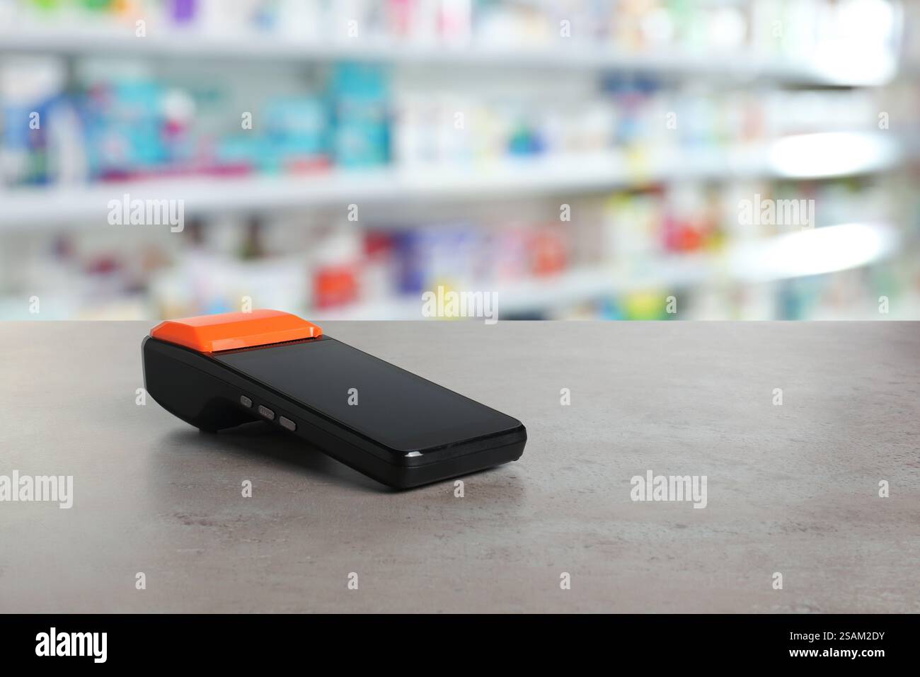 Payment terminal on counter in drugstore. Space for text Stock Photo ...