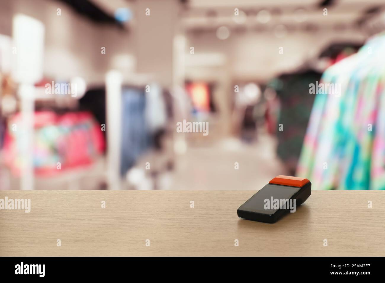Payment terminal on wooden counter in store Stock Photo - Alamy
