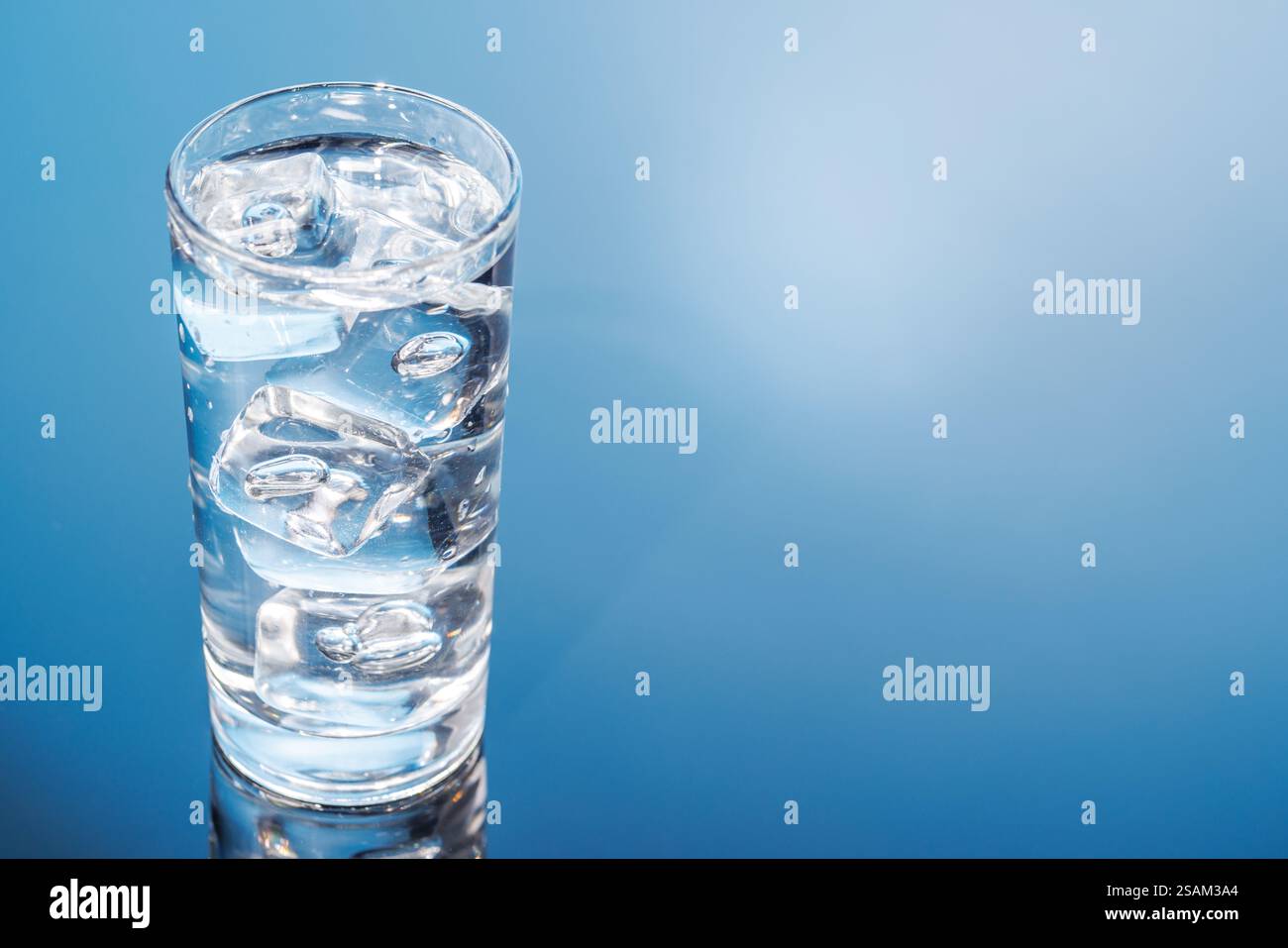 A clear glass filled with chilled water and ice cubes, creating a refreshing and cool drink. The ...