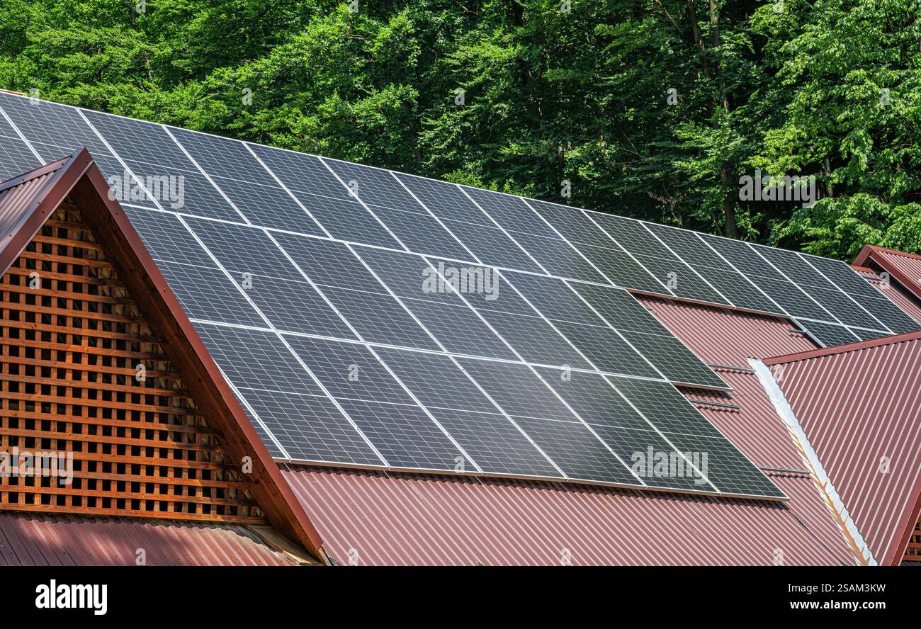Solar panels installed on a sloped roof Stock Photo - Alamy