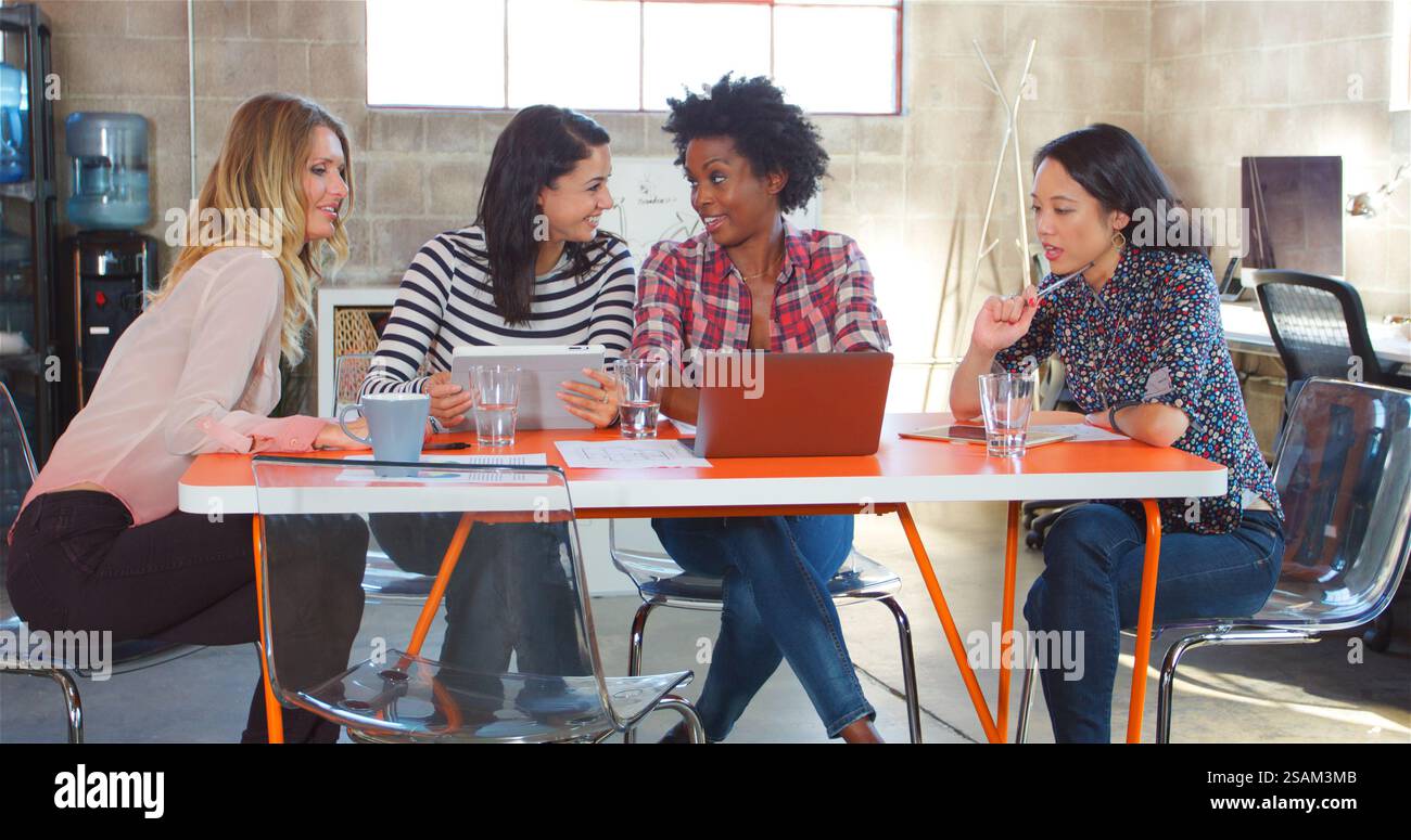 Group Of Female Designers Around Table Having Meeting In Creative ...