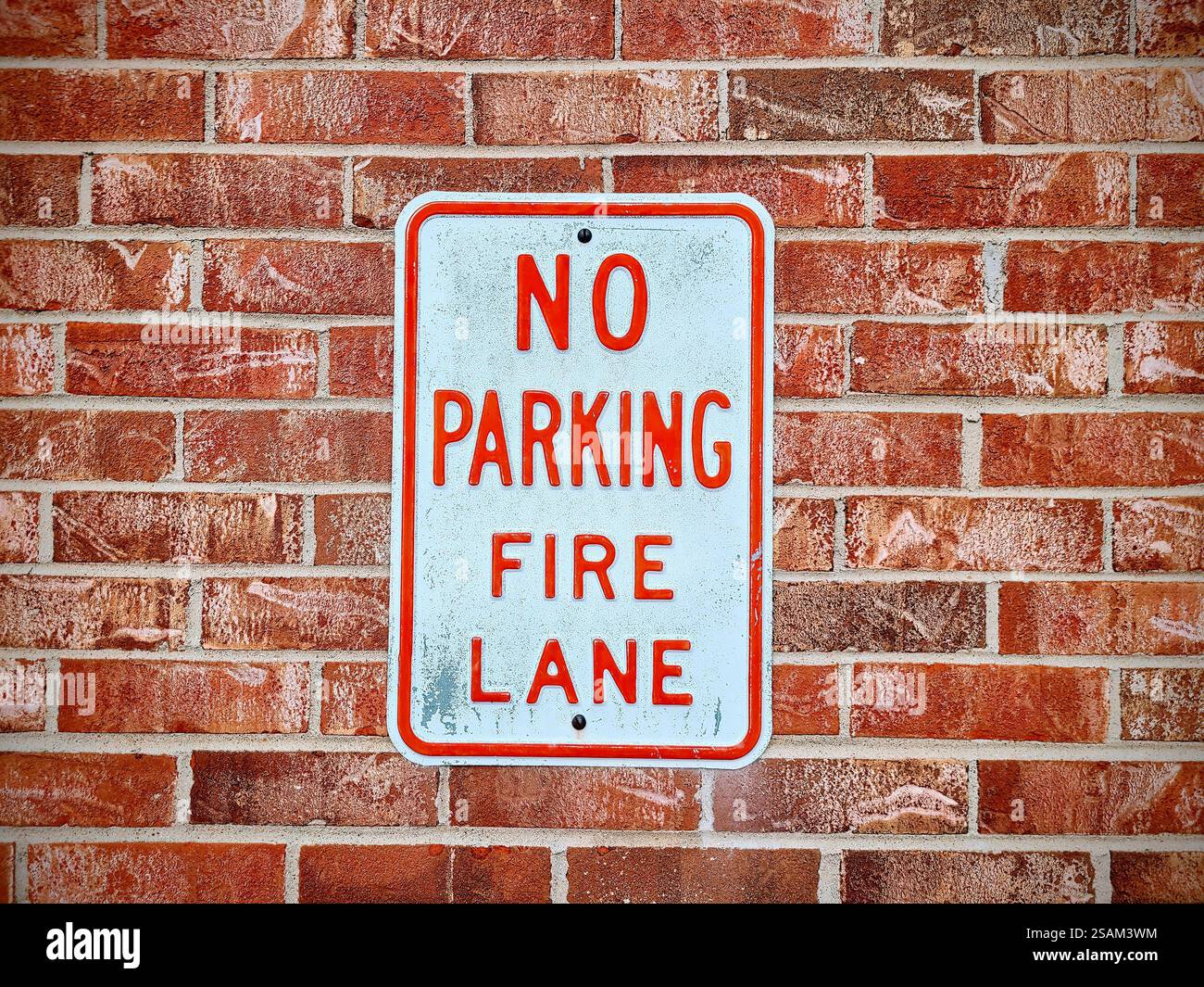 No Parking Fire Lane Sign on Brick Wall Eye Level View Stock Photo - Alamy