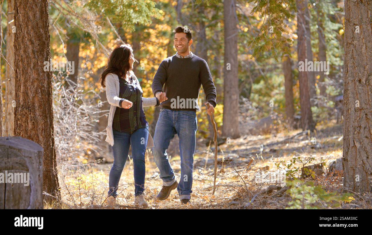 Active Mature Couple Outdoors Enjoying Autumn Or Fall Walk In Forest ...