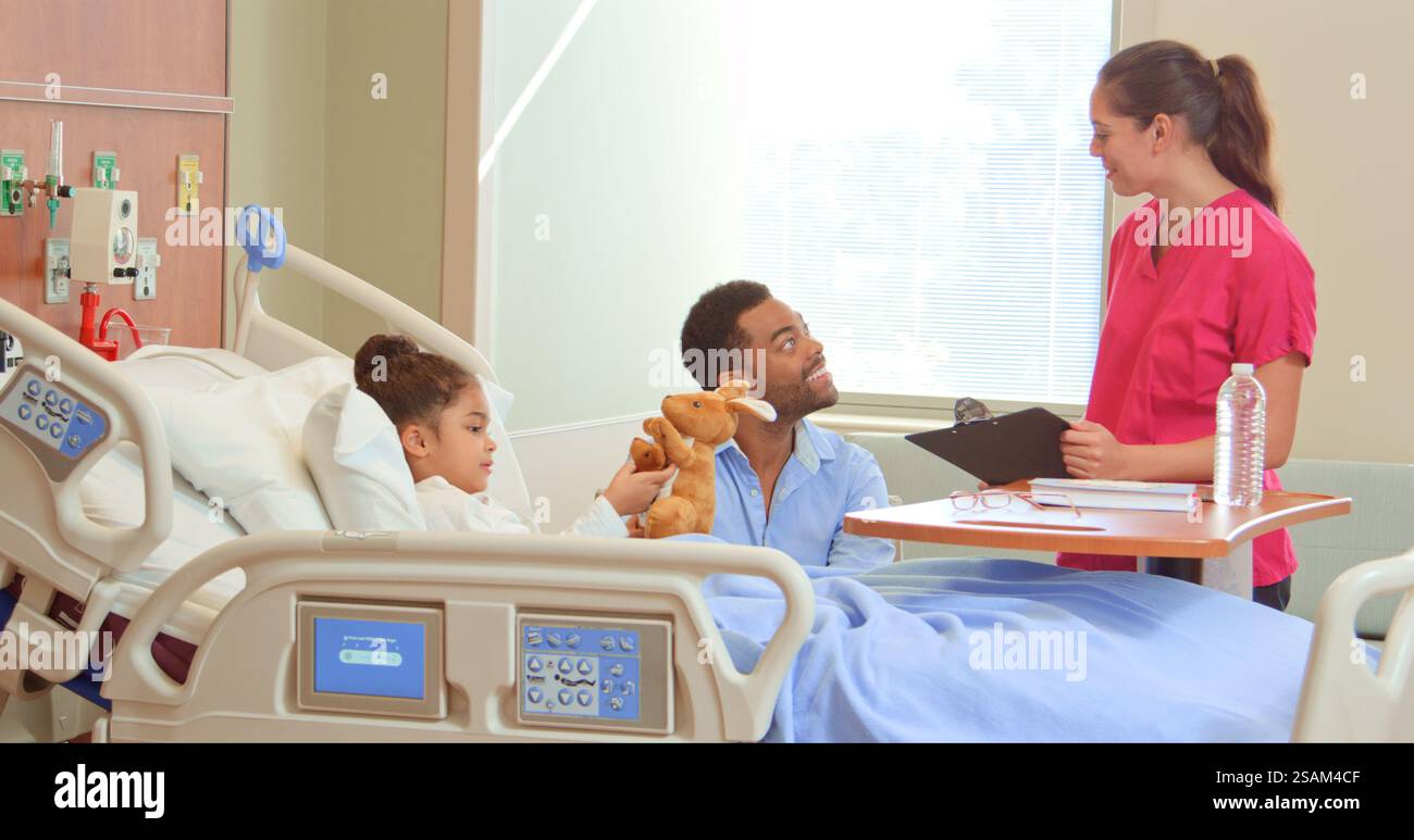 Female Doctor Or Nurse Wearing Scrubs Meeting With Father Visiting ...