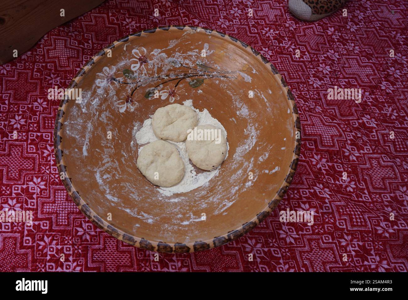 Handmade and homemade uncooked sourdough bread on a clay bowl with ...