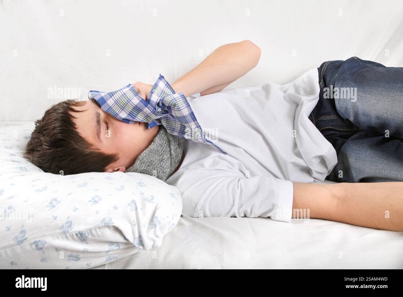 Young Man fell ill and Lying on the Bed with Handkerchief Stock Photo ...