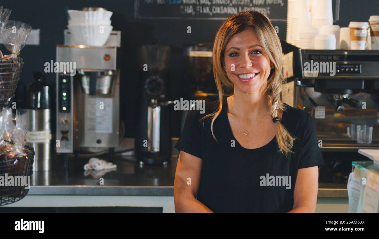 Portrait Of Smiling Female Barista Behind Counter In Coffee Shop Stock ...