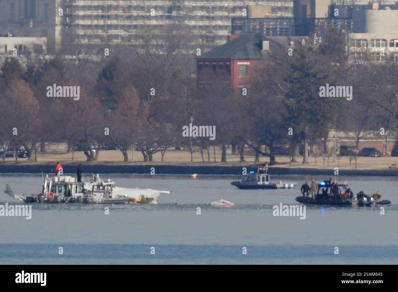 Search and rescue efforts are seen around a wreckage site in the ...