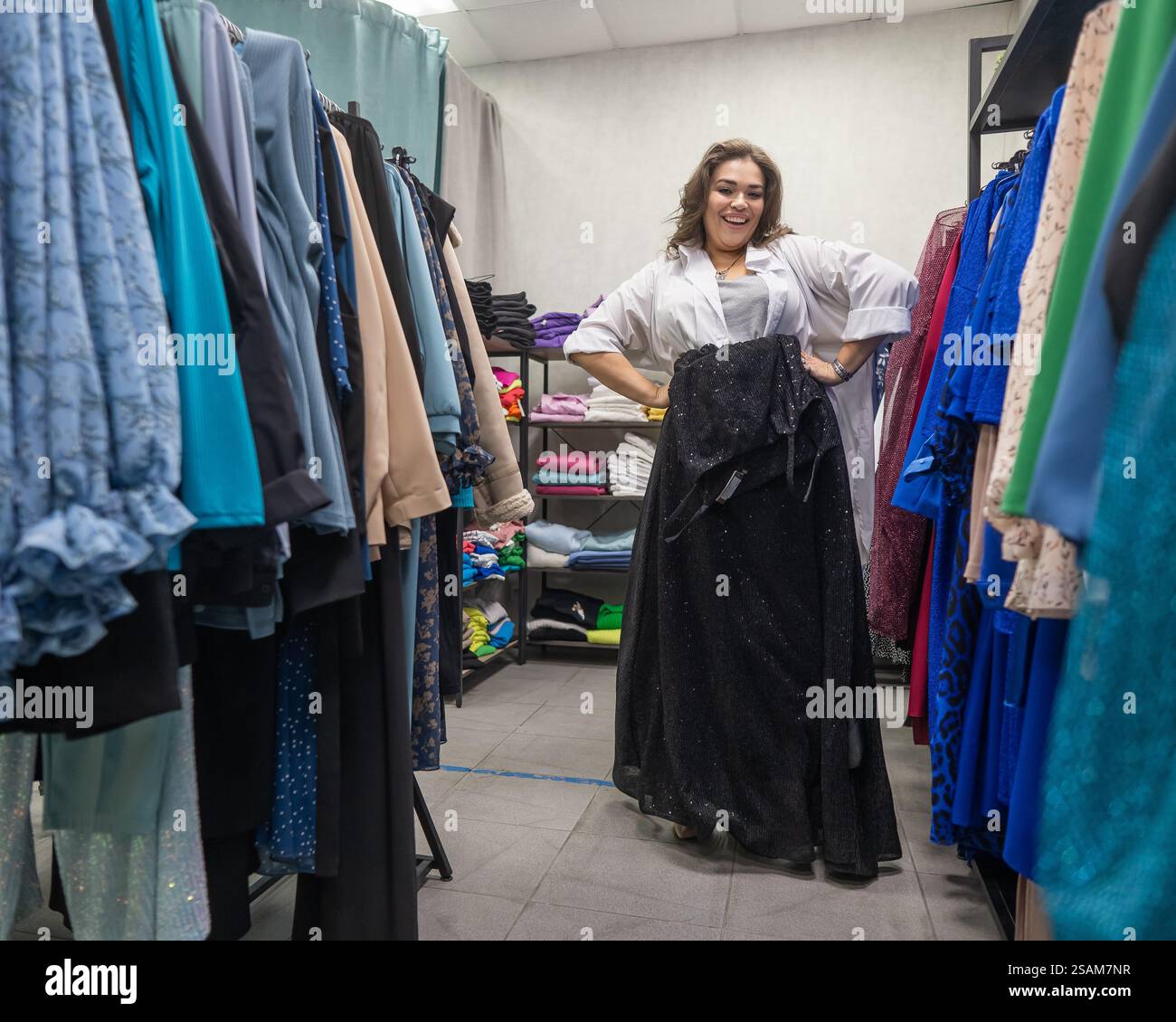 A fat woman chooses clothes in a plus size store Stock Photo - Alamy
