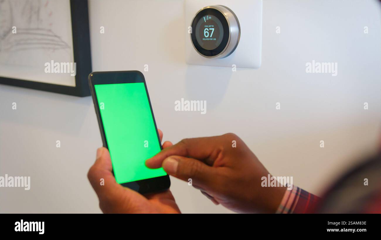 Close Up Of Man Setting Smart Heating Thermostat Using Green Screen ...