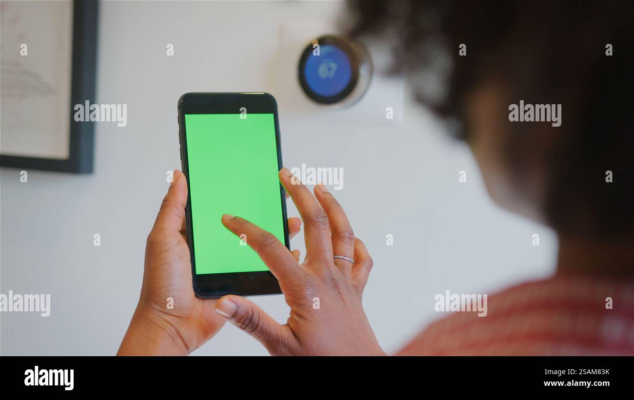 Close Up Of Woman Setting Smart Heating Thermostat Using Green Screen ...
