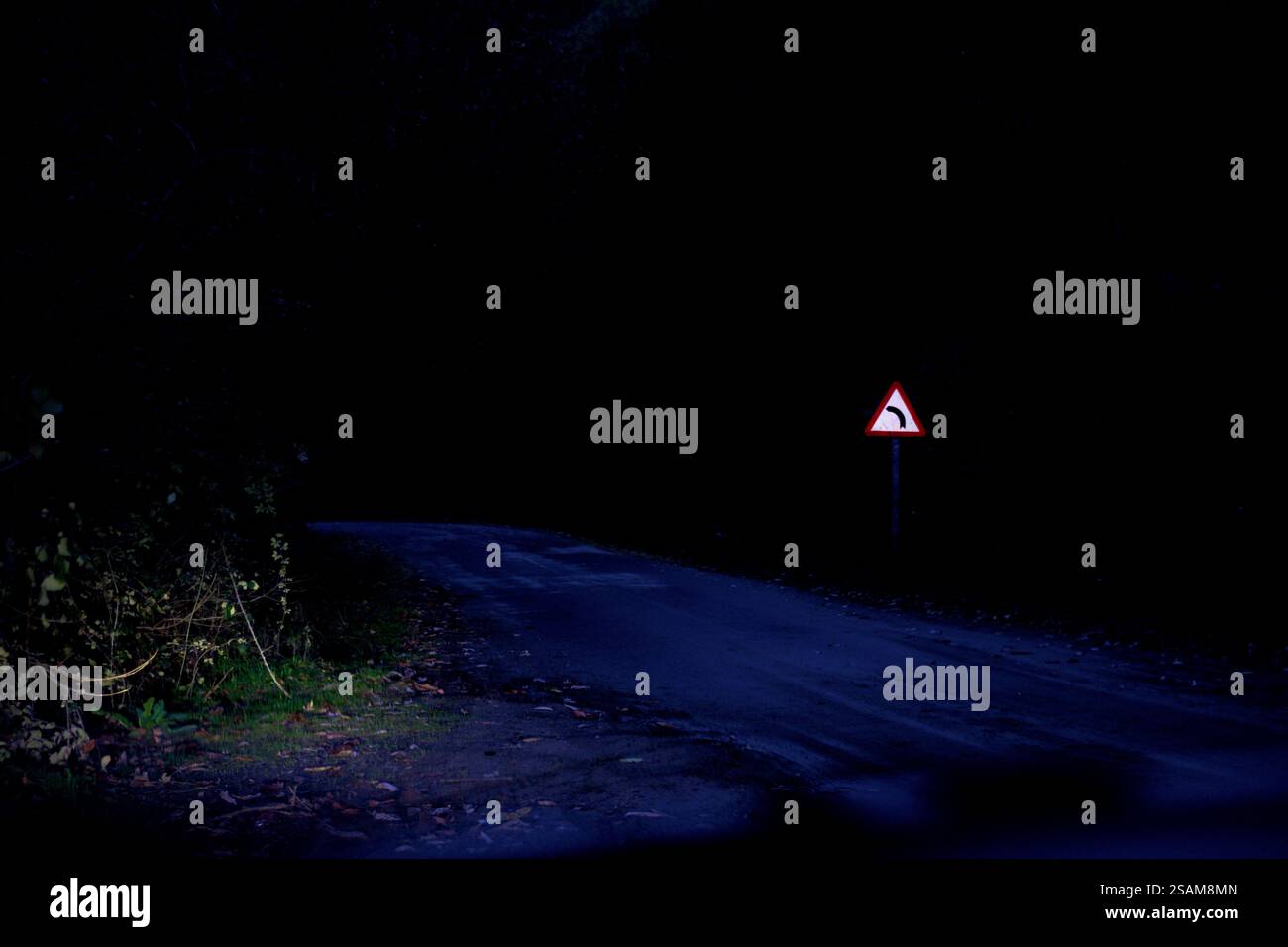 Dangerous curve sign at night with poor visibility from the car Stock ...
