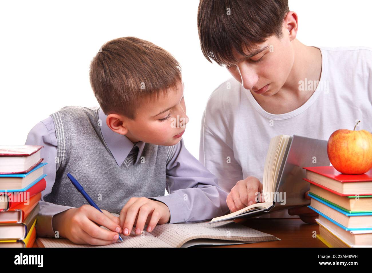 Older Brother helps Little Brother with a homework on the white ...