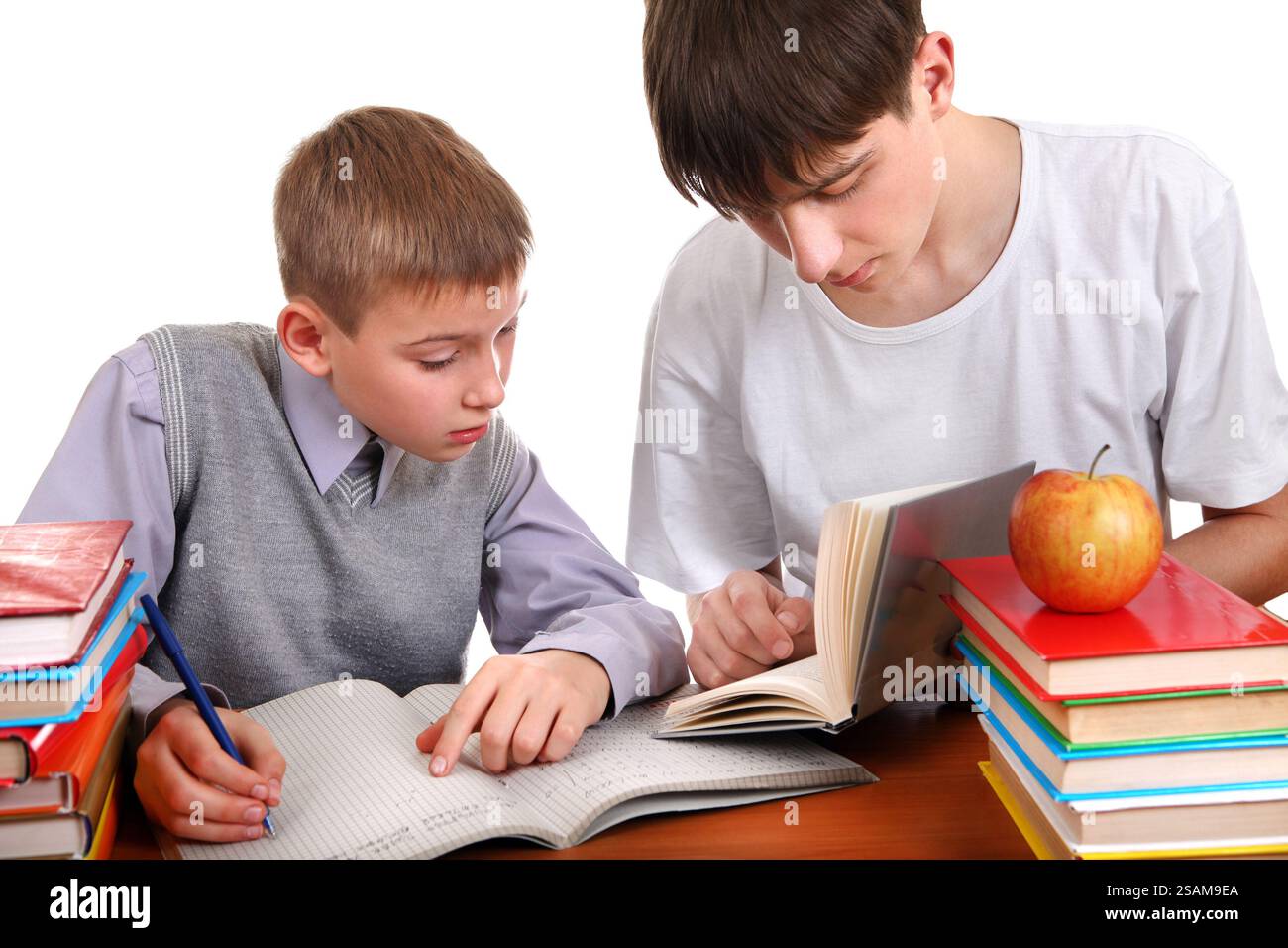 Older Brother helps Little Brother with a homework on the white ...