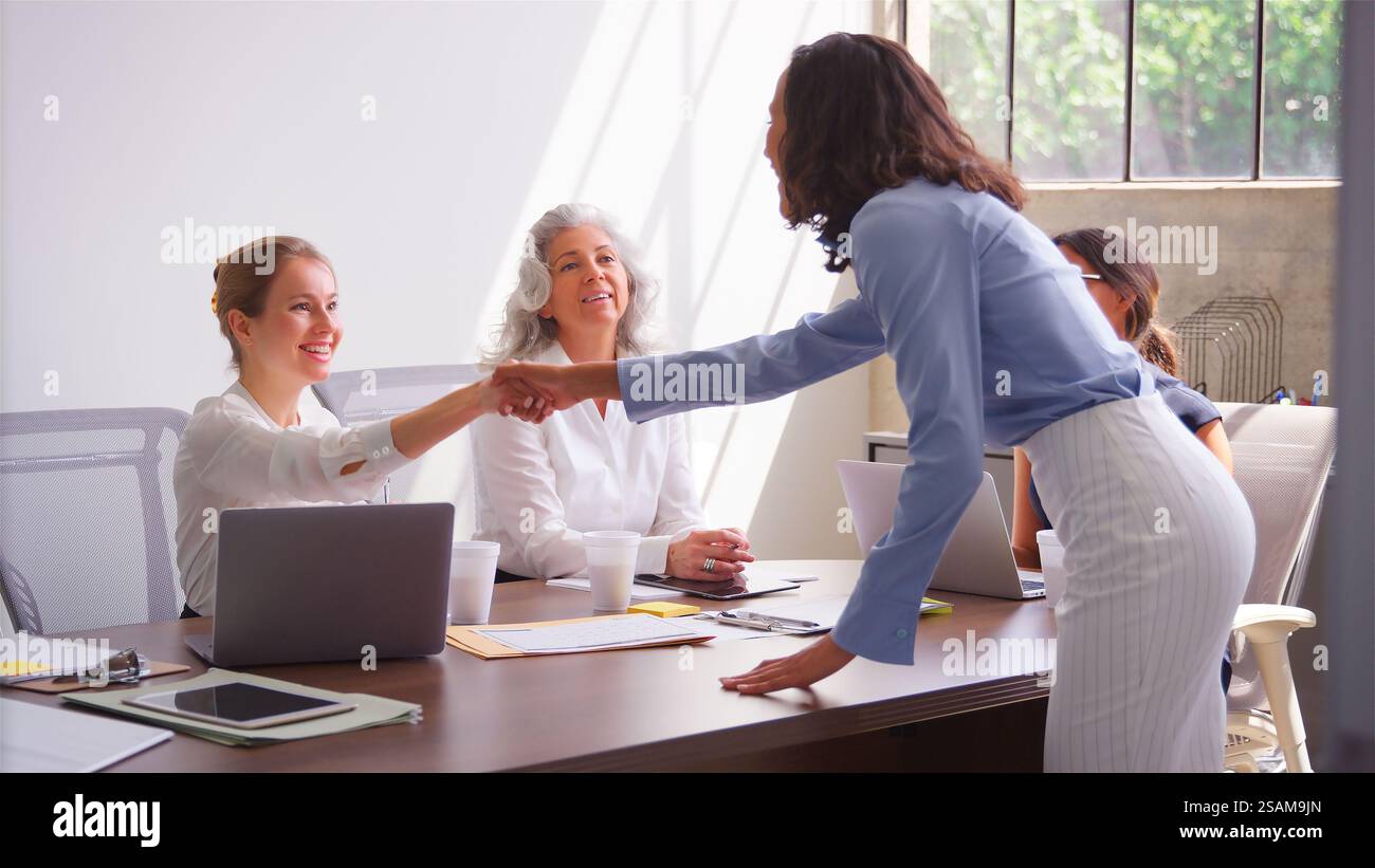 Female colleagues shaking hands in hi-res stock photography and images ...