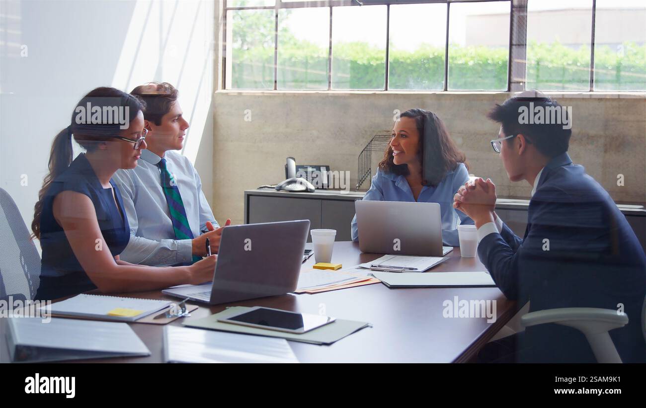 Business Team Meeting Around Table In Modern Office For Presentation ...