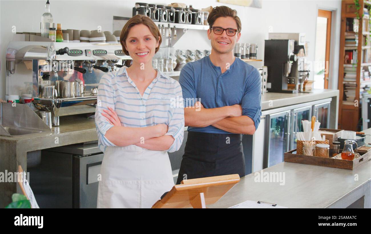 Portrait Of Smiling Male And Female Owners Or Workers Behind Counter In ...